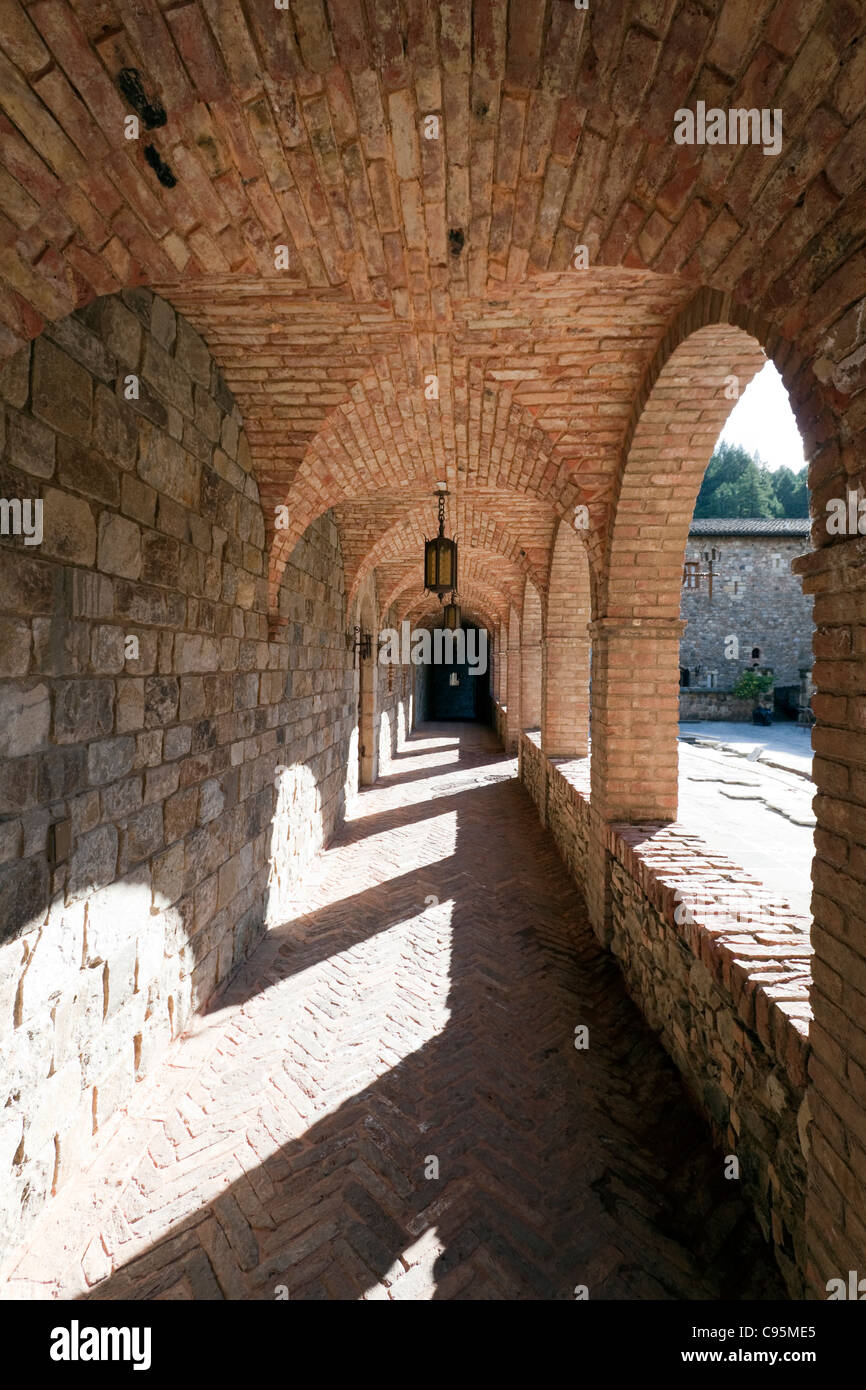 A stone corridor leading one around a courtyard Stock Photo - Alamy