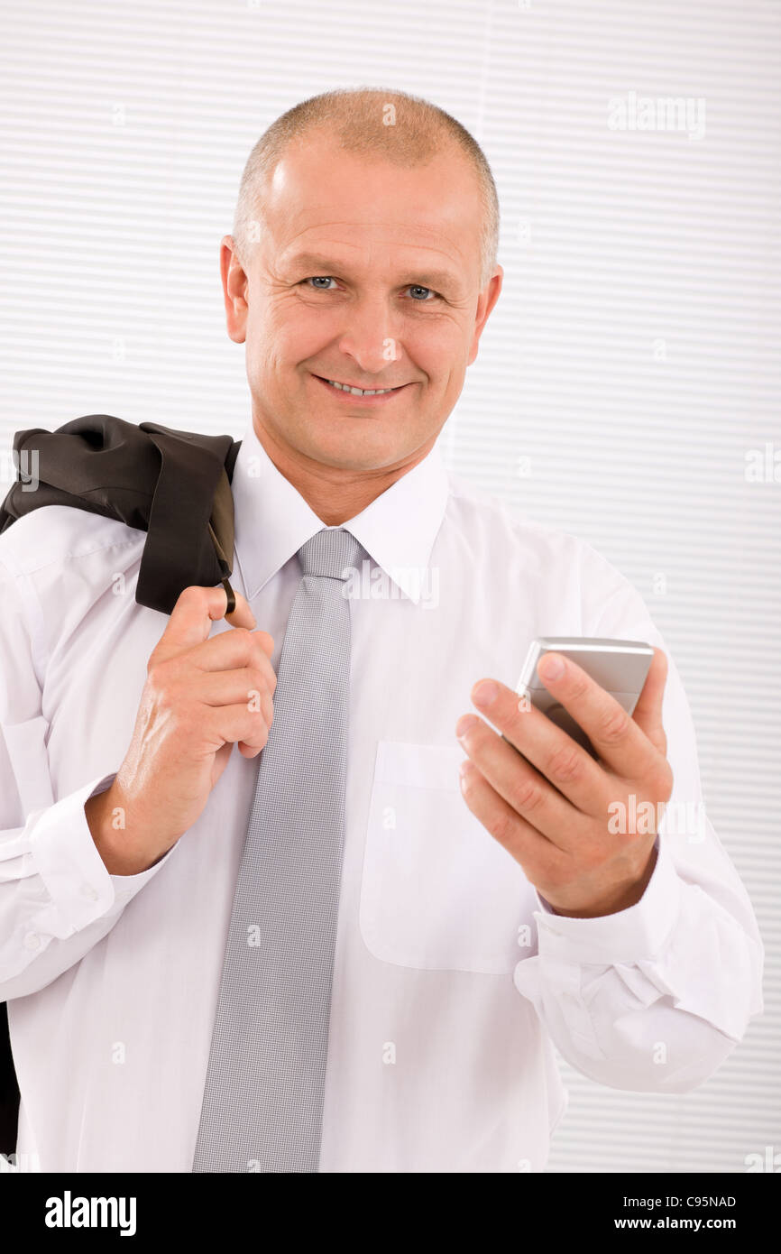 Mature handsome businessman wear suit with phone jacket over shoulder ...