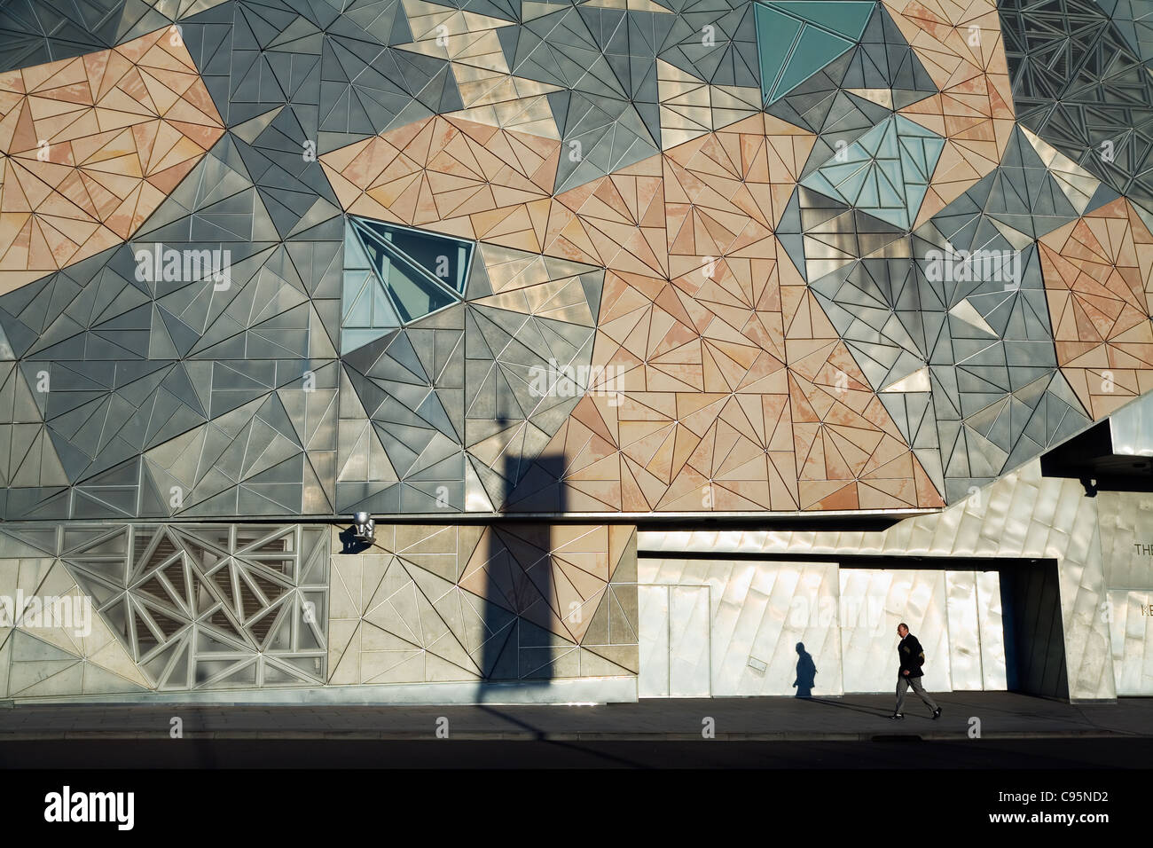 Man walking past the iconic architecture of the Ian Potter Centre, part ...