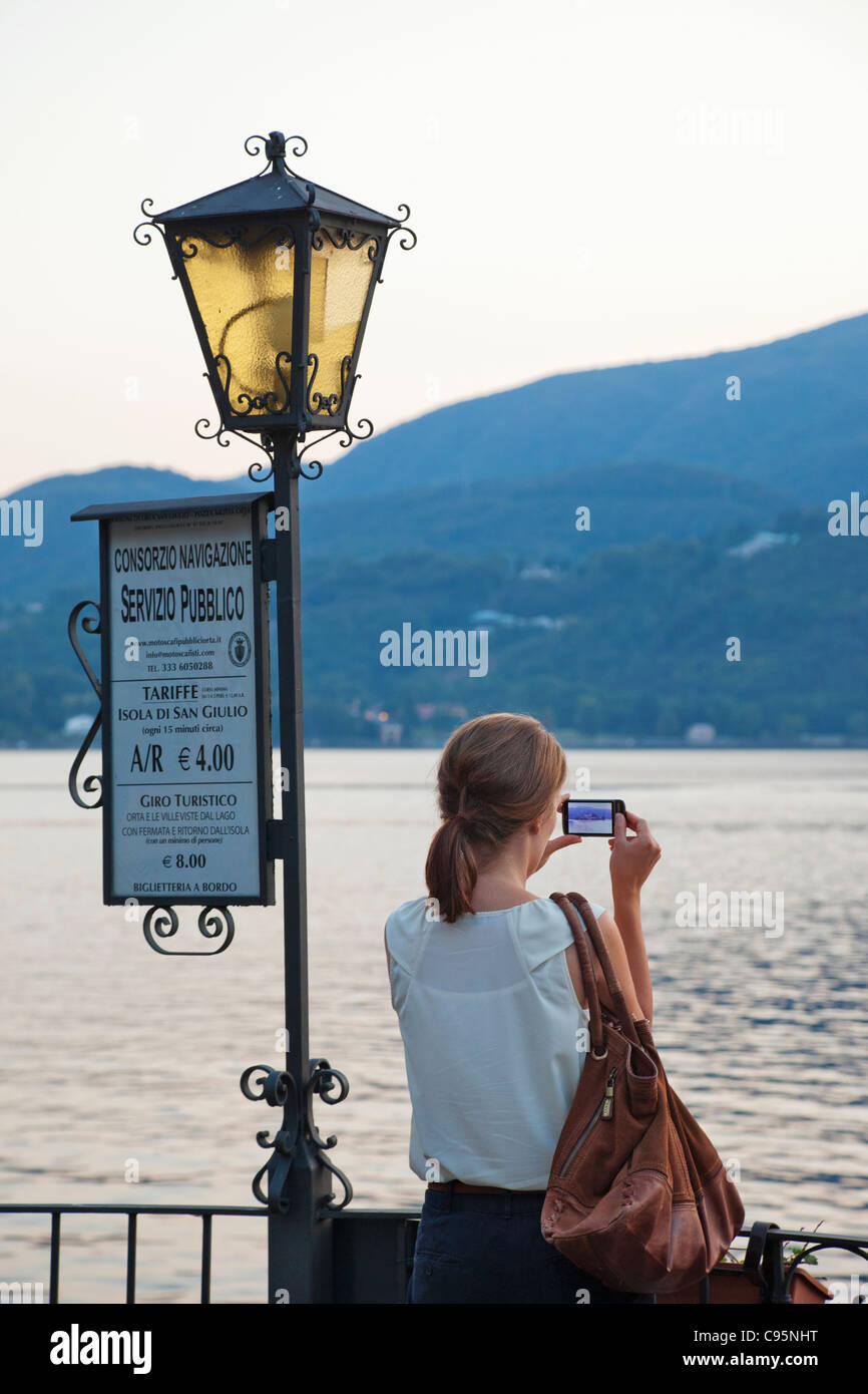 Italy, Piedmont, Lake Orta, Orta Town, Girl Taking Photo by Lakeside ...