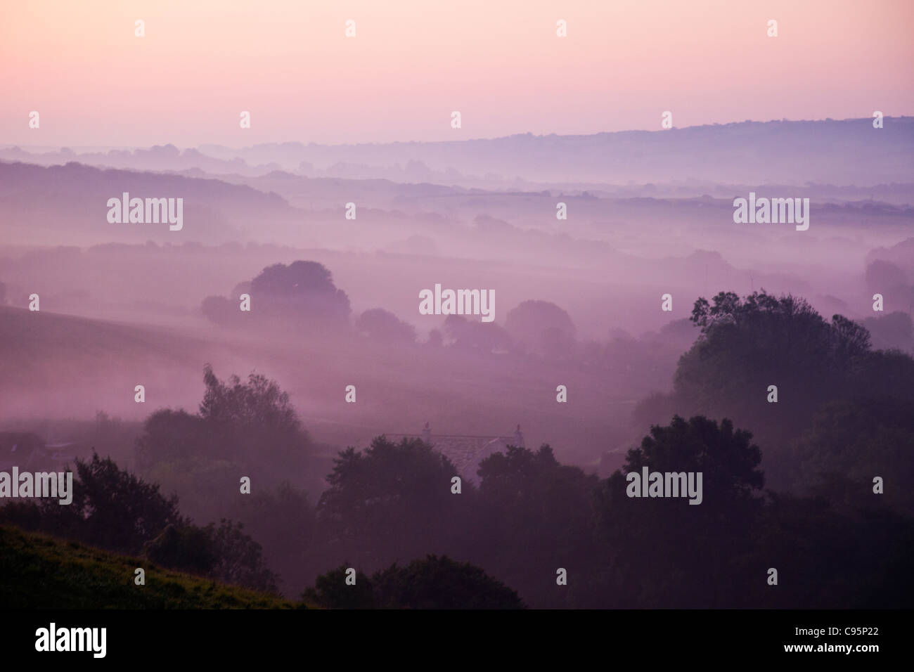 England, Dorset, Dawn over The Isle of Purbeck near Corfe Castle Stock ...