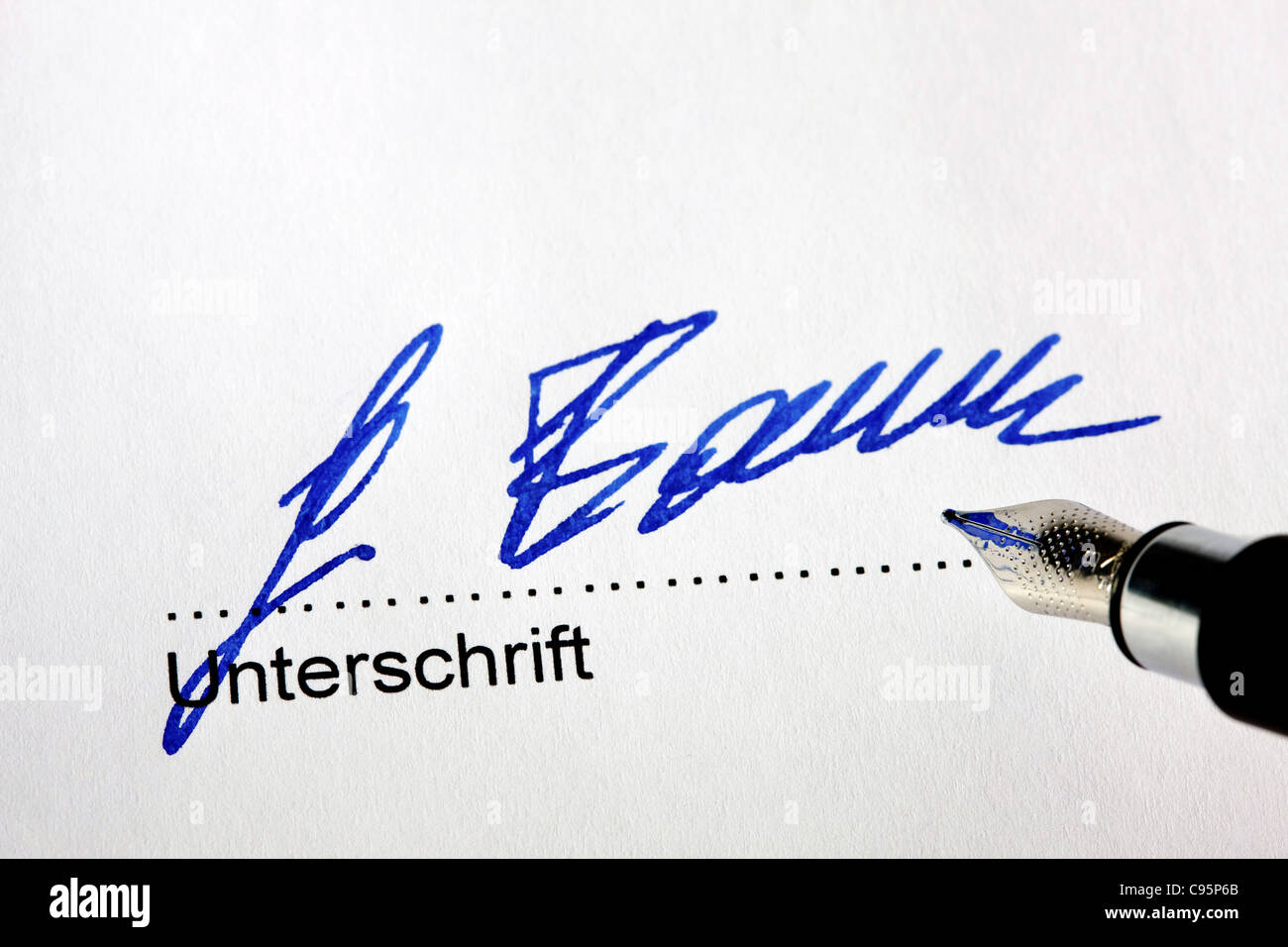 Handwritten signature with pen on a letter Stock Photo - Alamy
