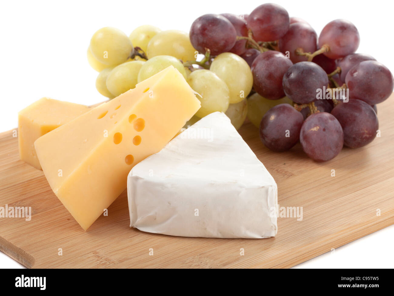 Swiss and Brie Cheese with Red and Green Grapes on White Isolated ...