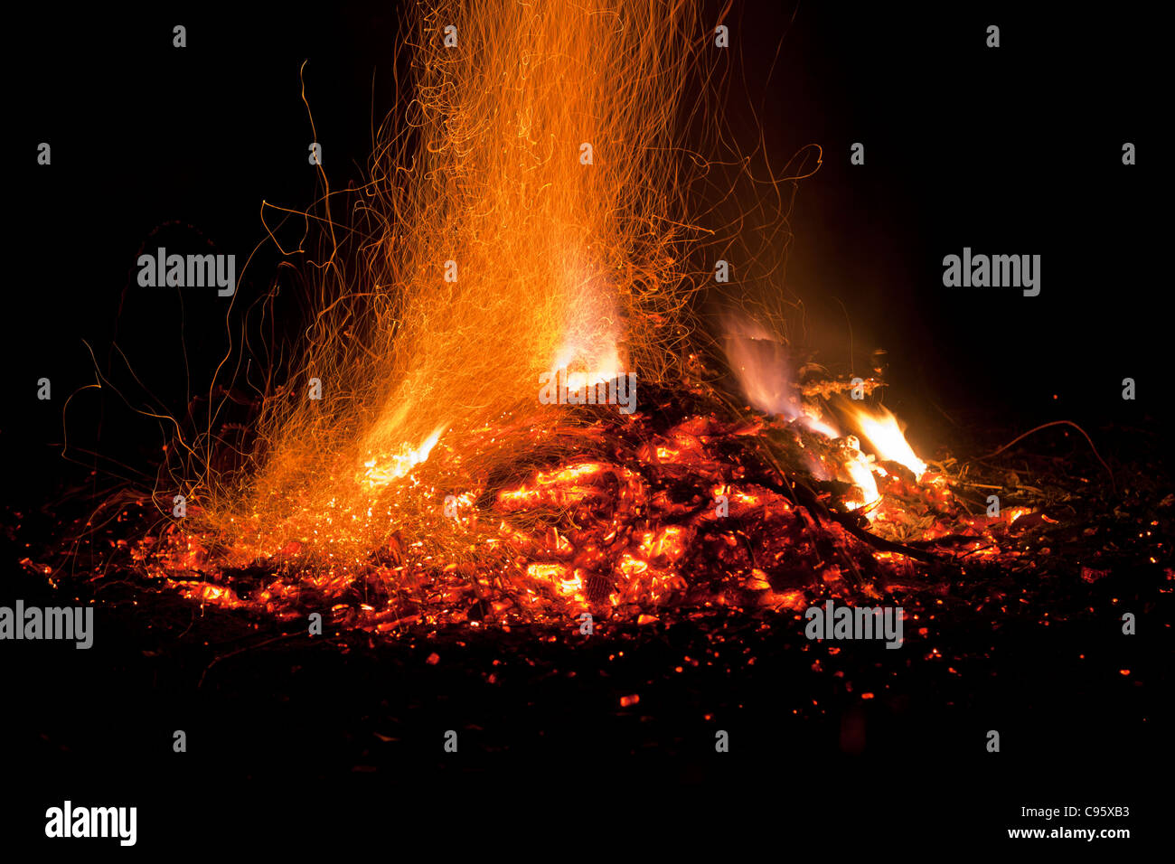 Fire with flames and sparks. Intense orange, yellow glow of bonfire ...
