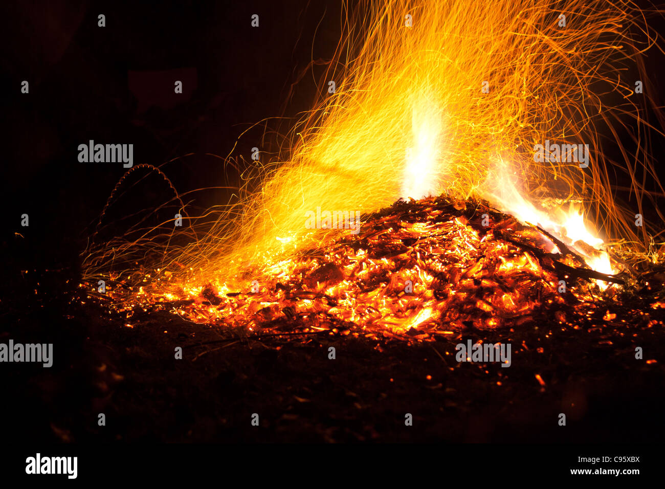 Fire with flames and sparks. Intense orange, yellow glow of bonfire ...