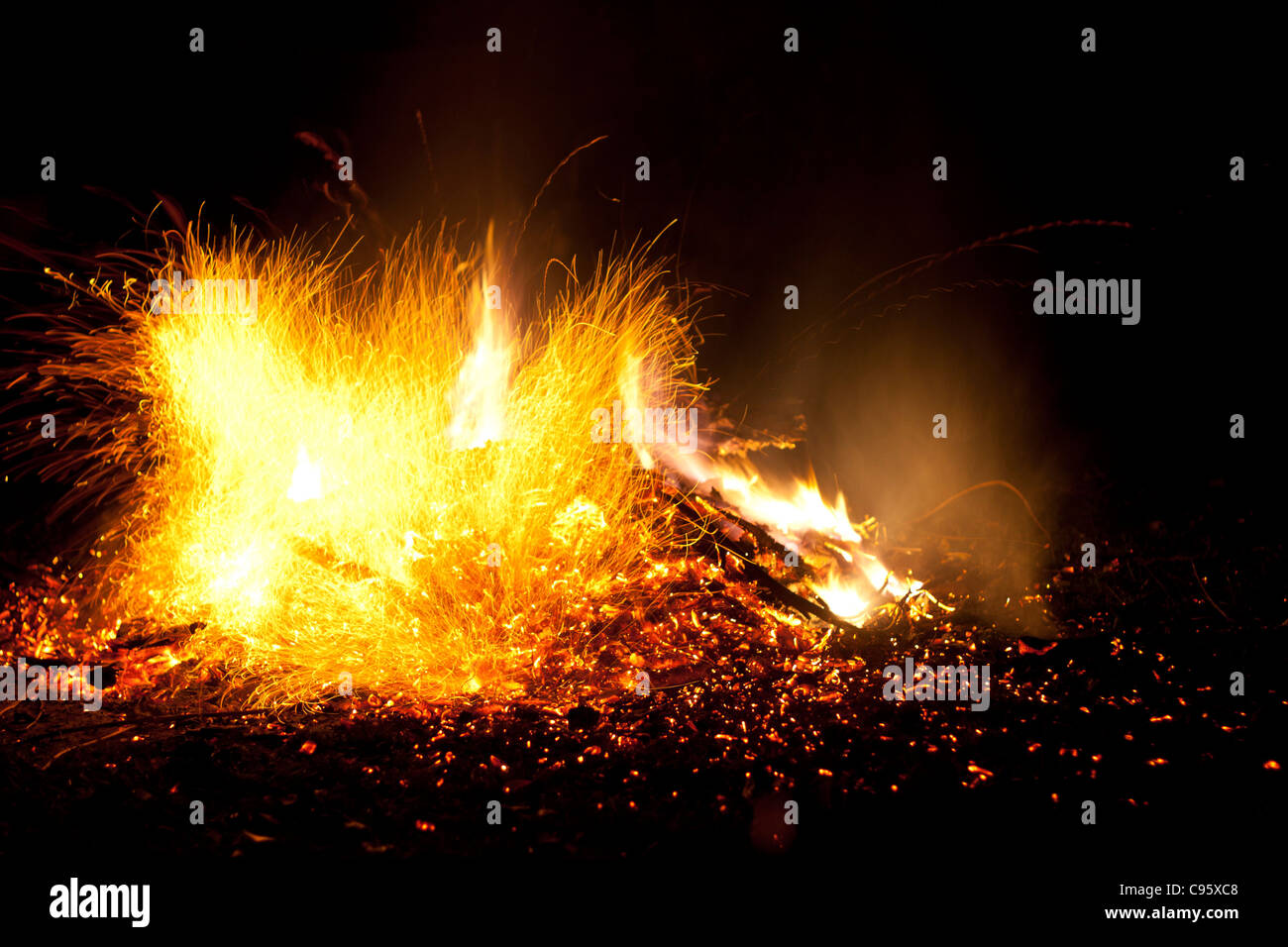 Fire with flames and sparks. Intense orange, yellow glow of bonfire ...