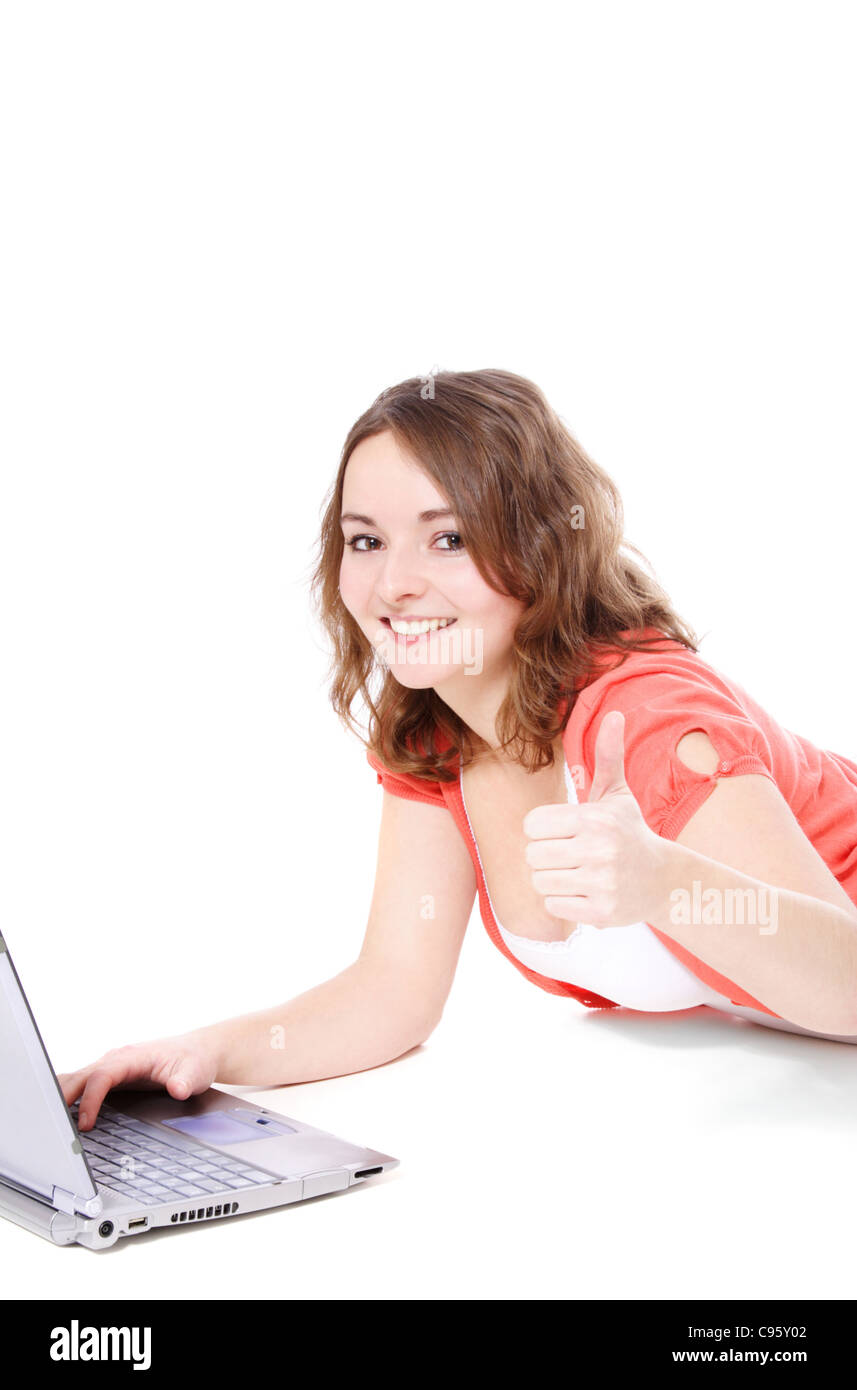 Attractive young woman cheers while using her notebook computer. All on ...