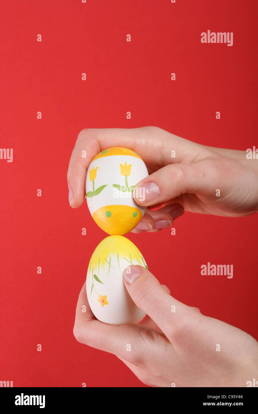 Bumping painted eggs in easter day Stock Photo - Alamy