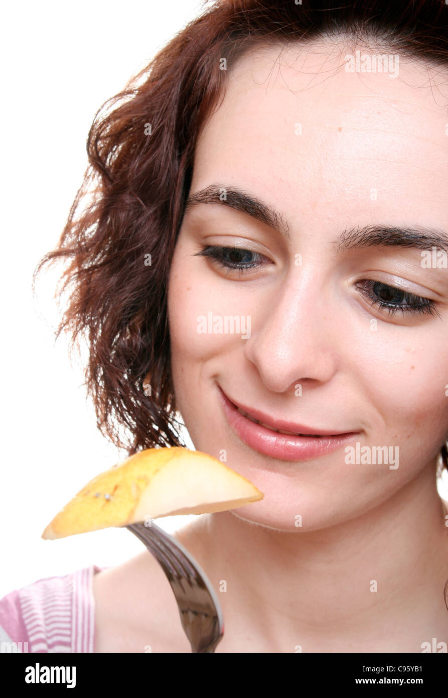 Woman eating tasty pear with fork Stock Photo - Alamy