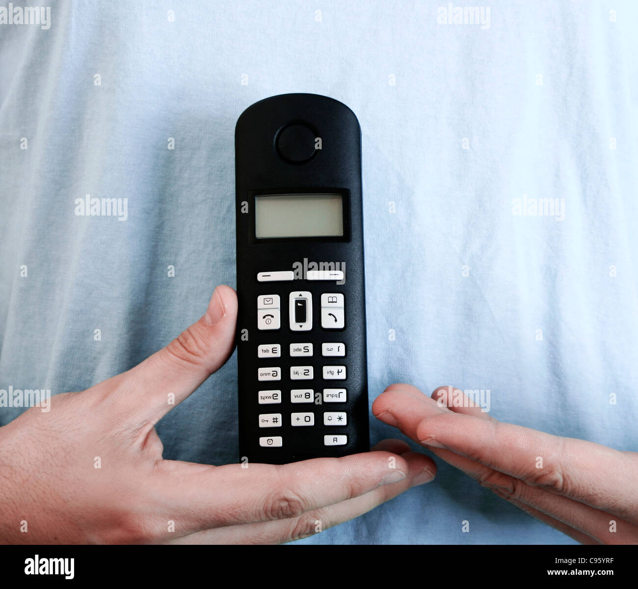 Cell Phone in a man hand. On blue background Stock Photo - Alamy
