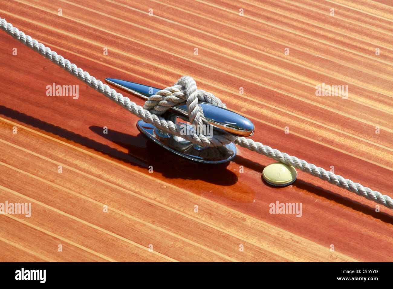 Rope block detail on old motor boat wooden deck Stock Photo - Alamy