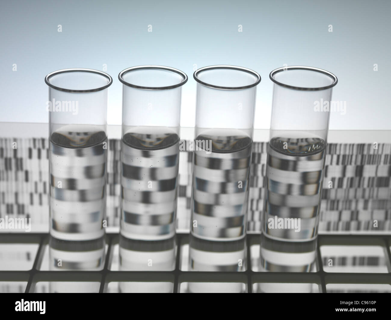Genetic research. Test tubes sitting in front of a DNA ...