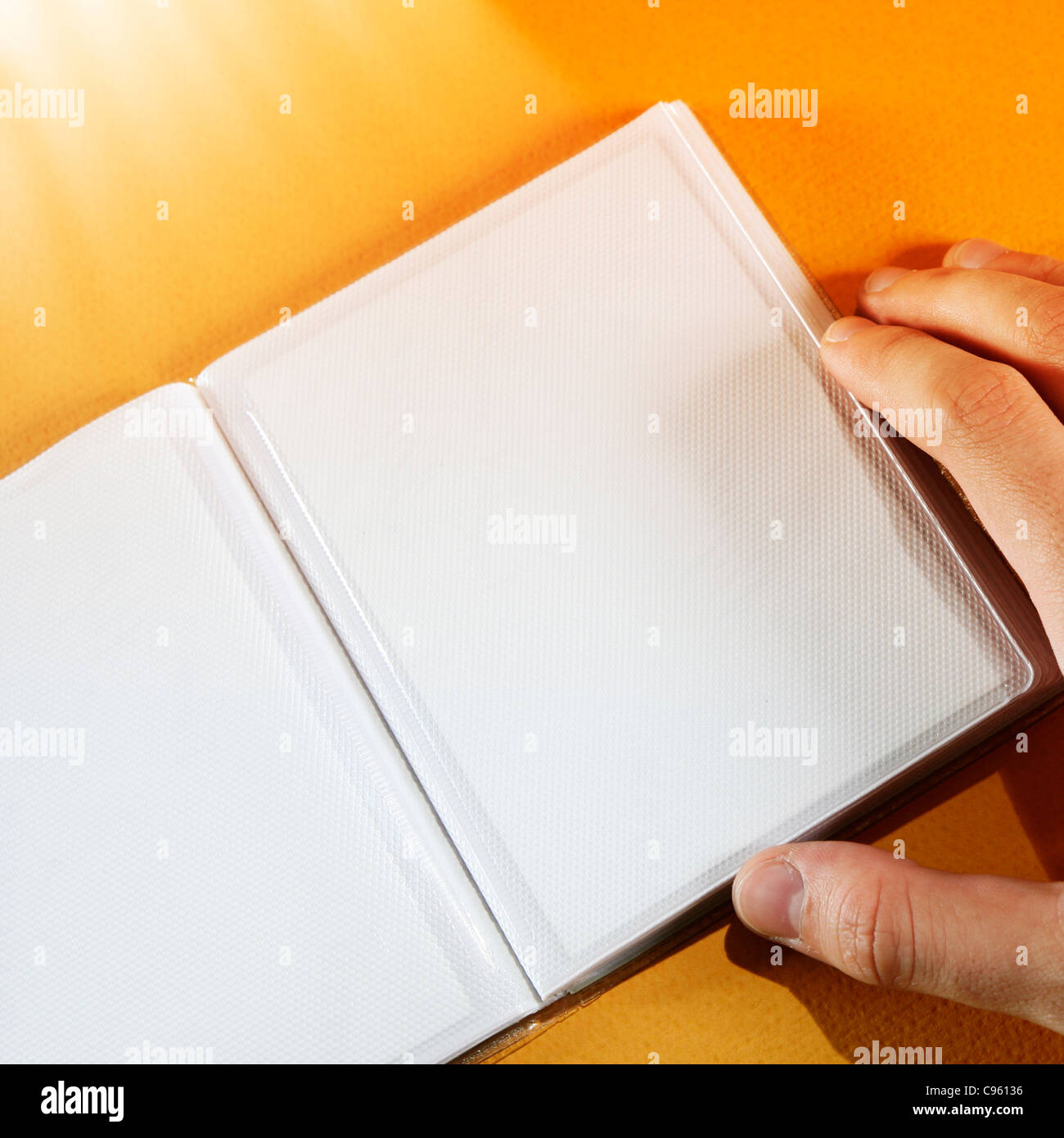 Opened empty photo album isolated on orange Stock Photo - Alamy