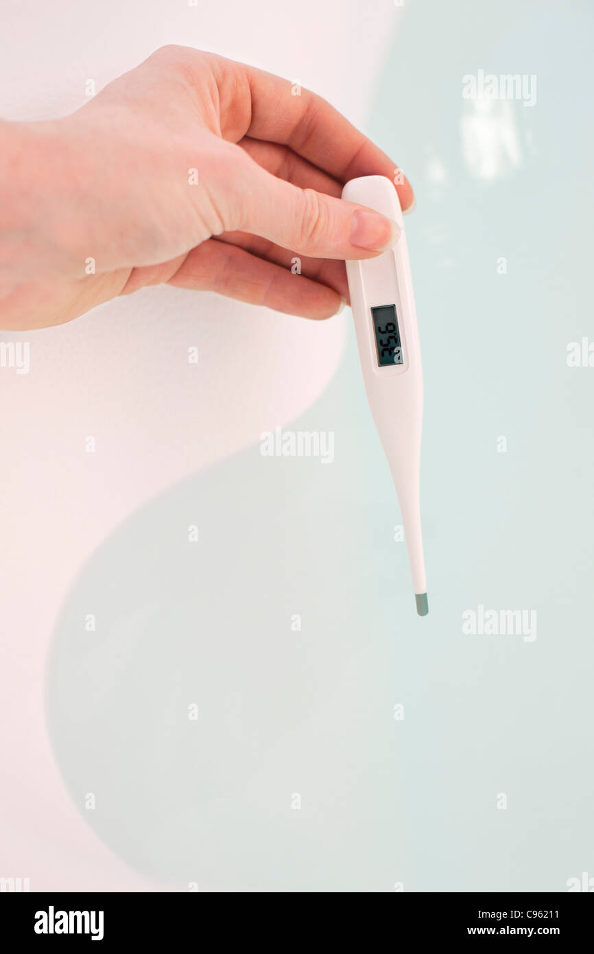 Testing water temperature Stock Photo - Alamy