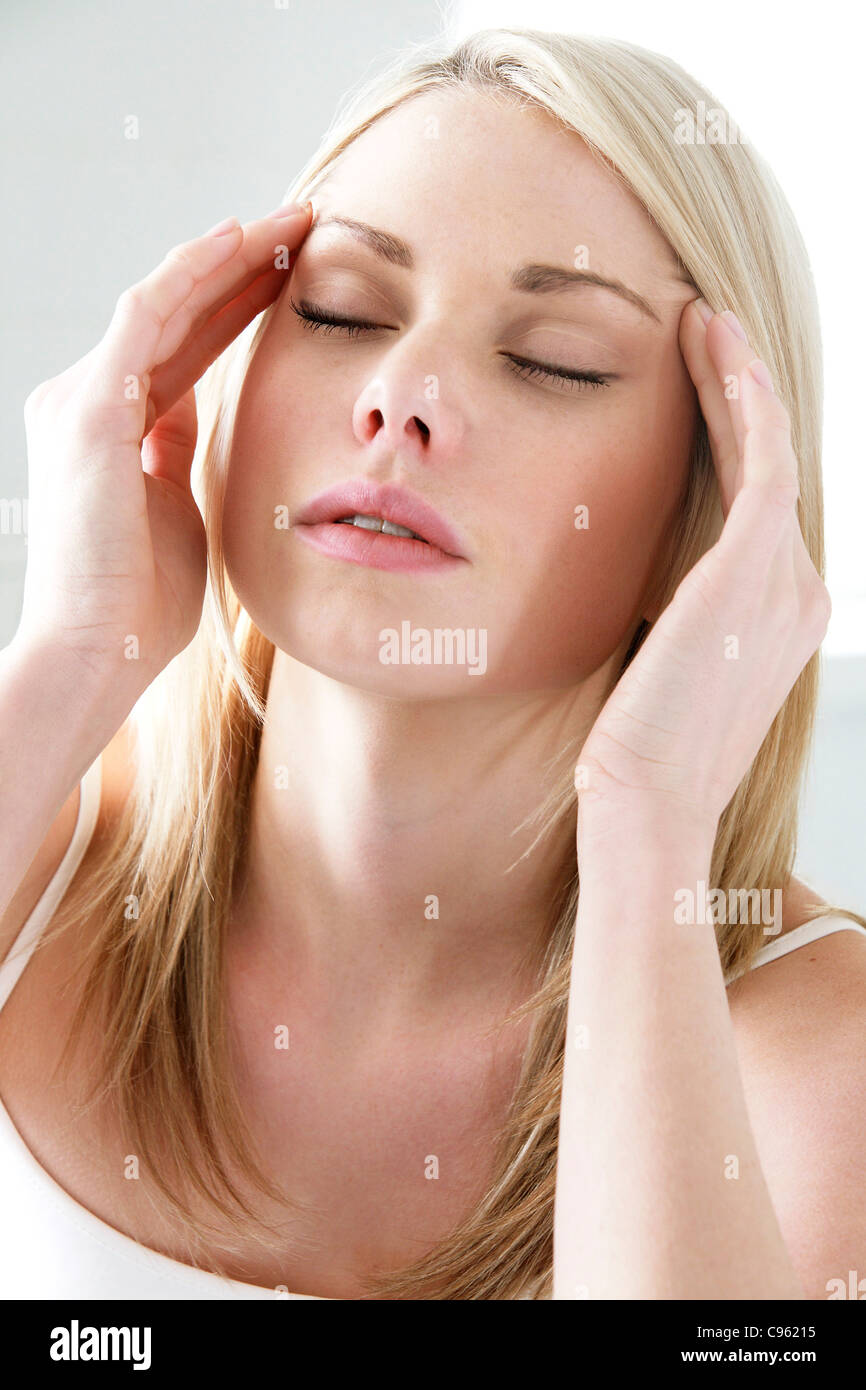 Blonde woman headache rubs temples hi-res stock photography and images ...