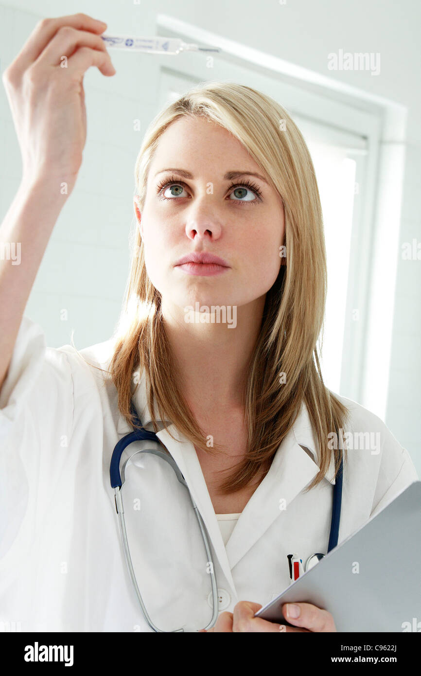 Doctor checking females temperature hi-res stock photography and images ...