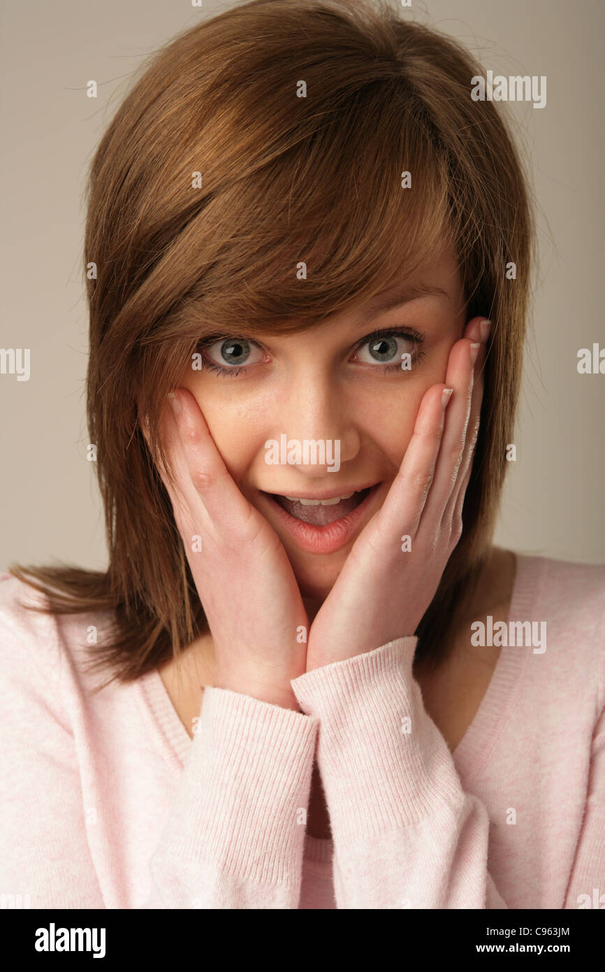 Teenage girl looking shocked Stock Photo - Alamy