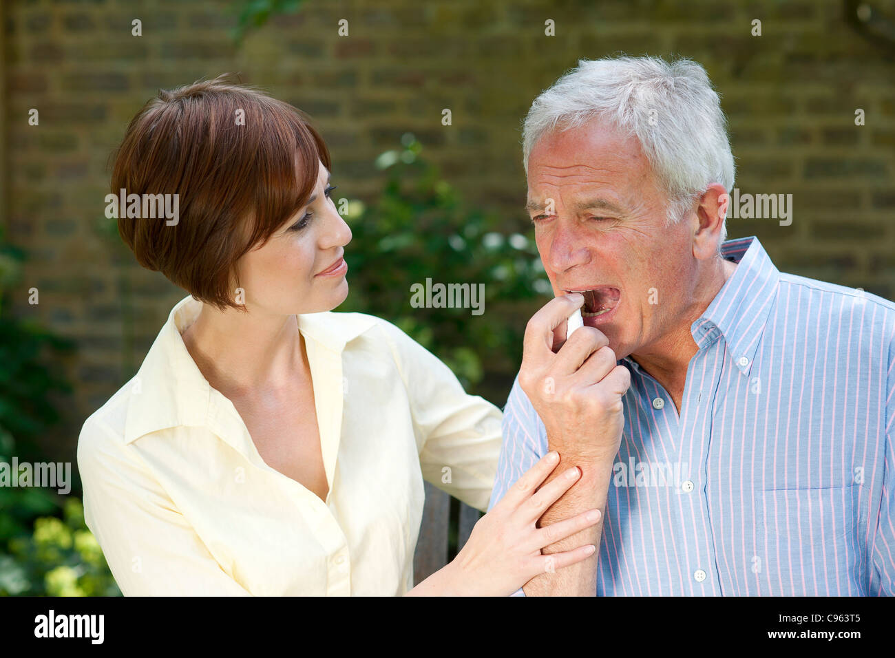 Man using angina spray Stock Photo - Alamy