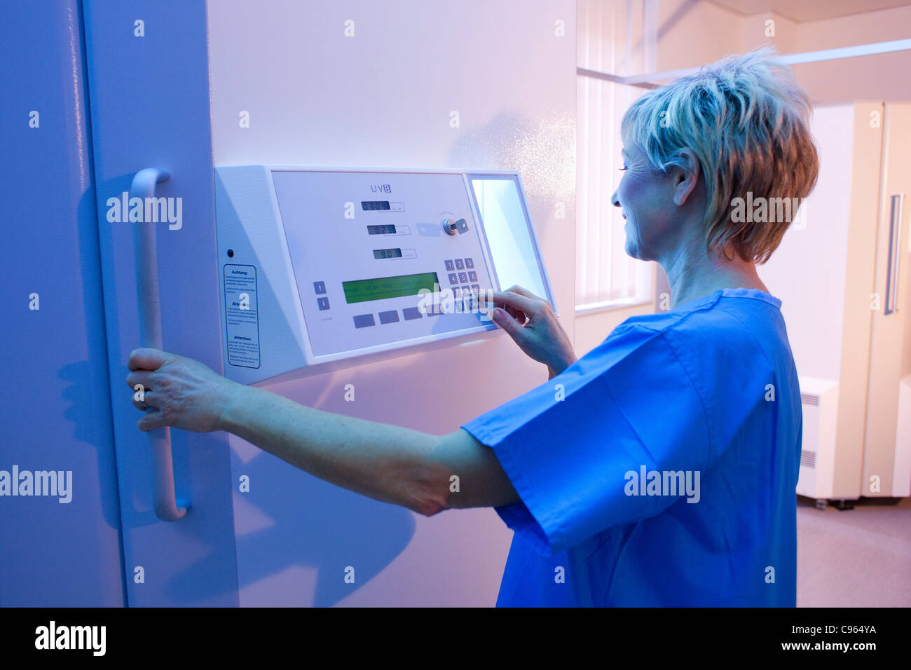 Phototherapy booth. Dermatologist setting up an ultraviolet B ...