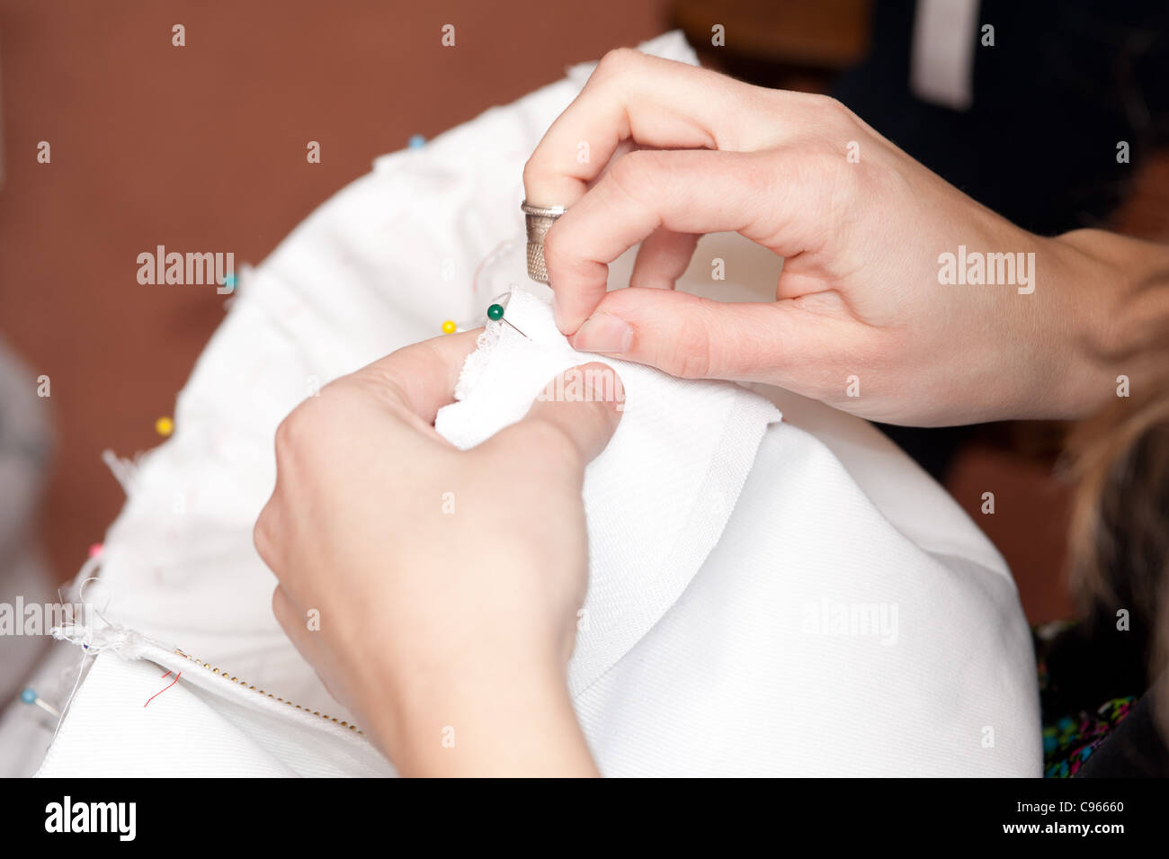 Hands pinning a garment for sewing Stock Photo - Alamy