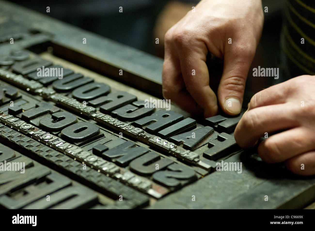 Hands arranging letters within print block for printmaking Stock Photo ...