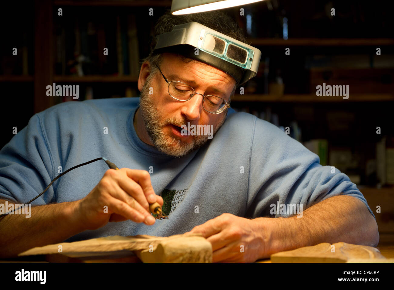 Man carving a bird decoy in his woodworking shop Stock Photo - Alamy