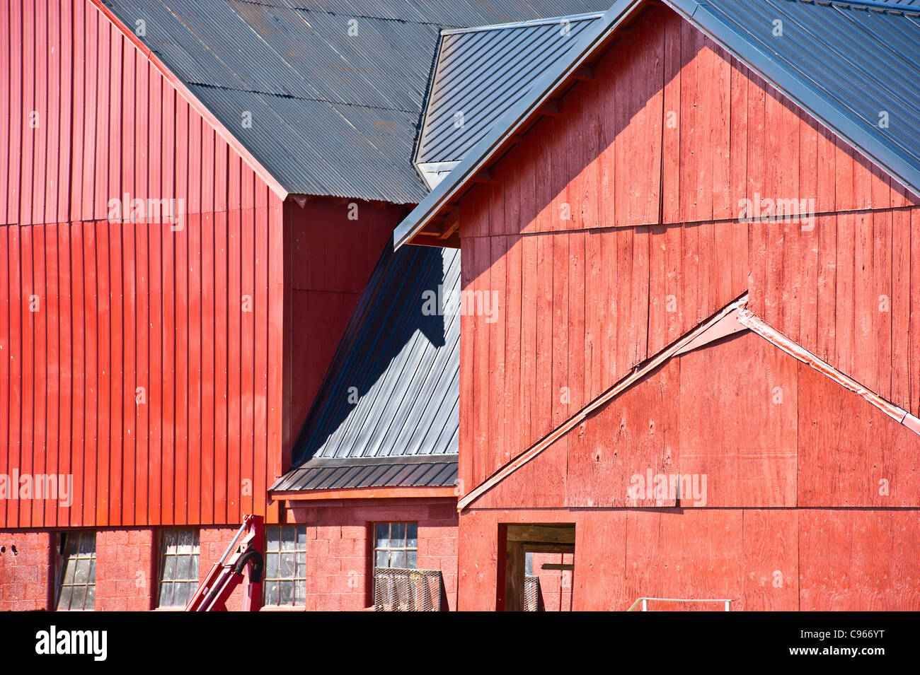 Varying shapes of roof and structure on side of red barn Stock Photo ...