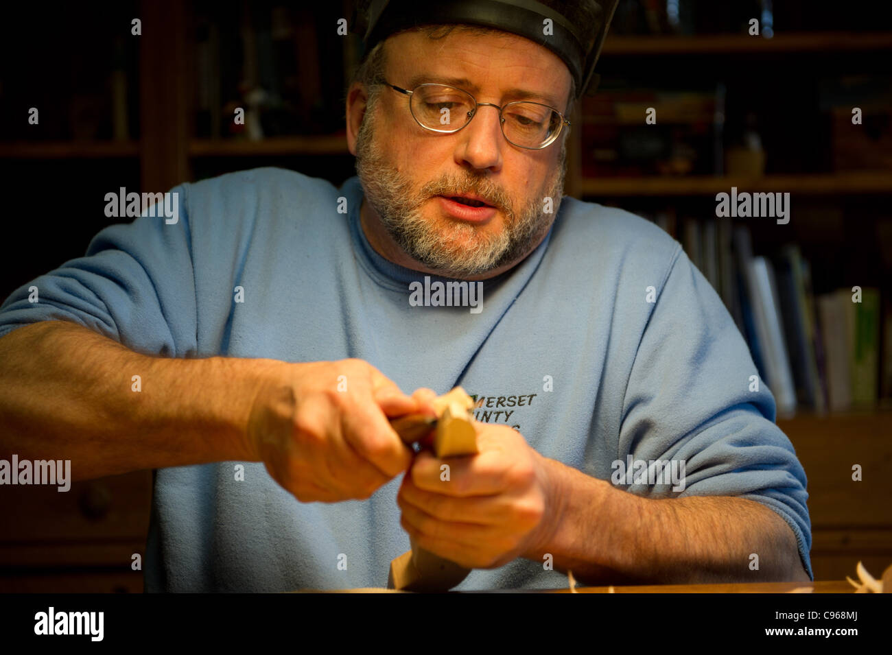 Man carving a bird decoy in his woodworking shop Stock Photo - Alamy