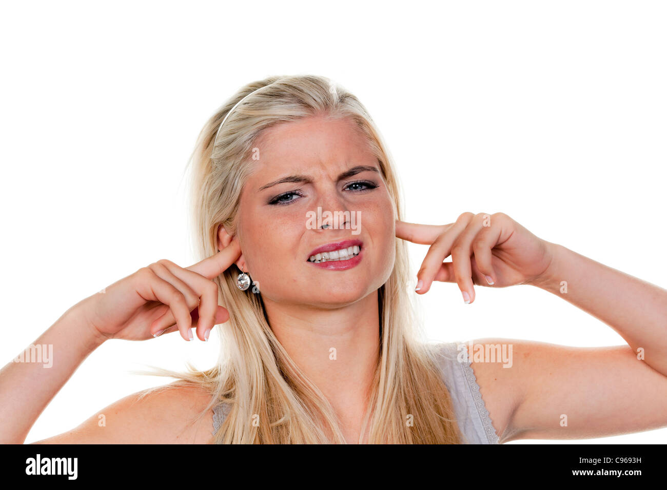 young woman suffering from noise, keeping ears shut Stock Photo - Alamy