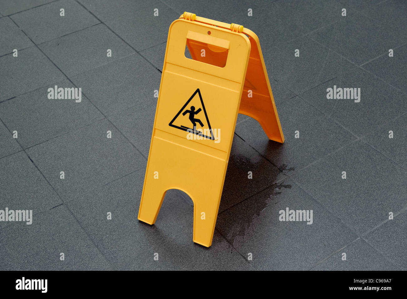 Bright yellow slippery floor warning sign Stock Photo - Alamy