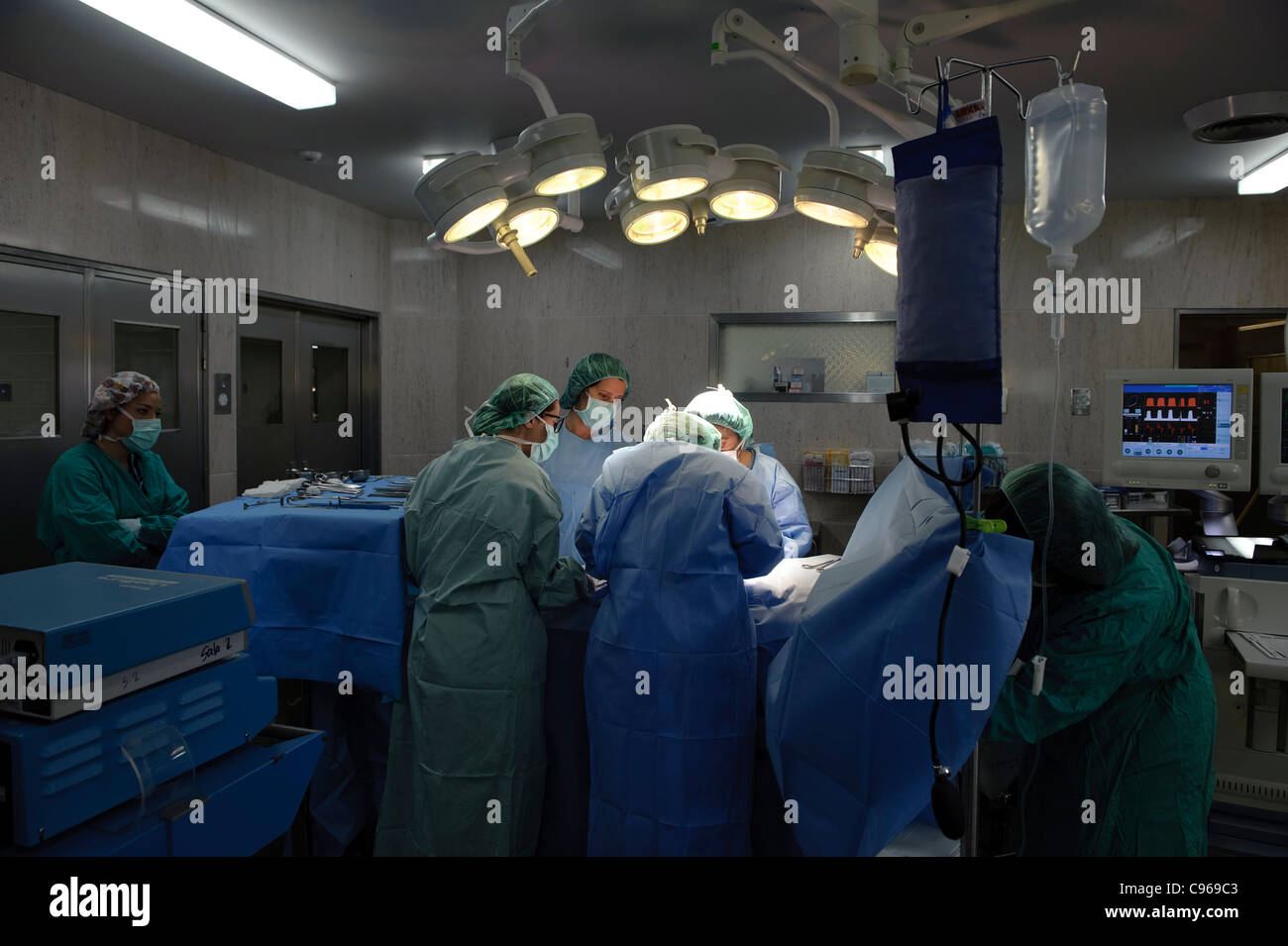 Doctors performing gynecological surgery in operating room Stock Photo ...