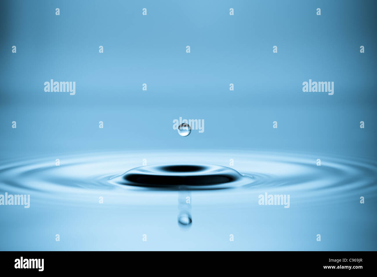 Water drop falling into water making a perfect droplet splash Stock Photo - Alamy
