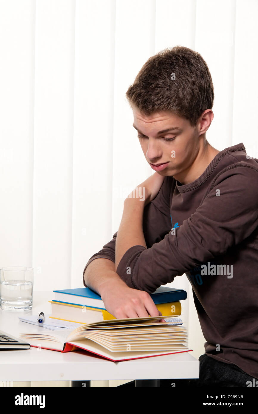 A young student learning with books Stock Photo - Alamy