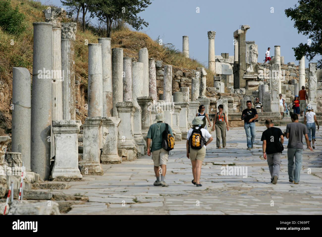 Tourists walking by ancient roman columns in Ephesus, Turkey Stock ...