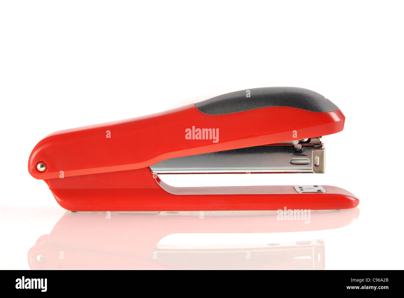 A red and black stapler isolated with reflection on white background ...