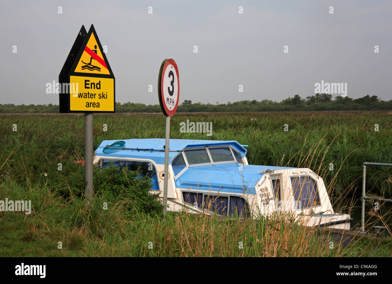 River signs and moored boat in dyke to Rockland Broad, Norfolk, England ...