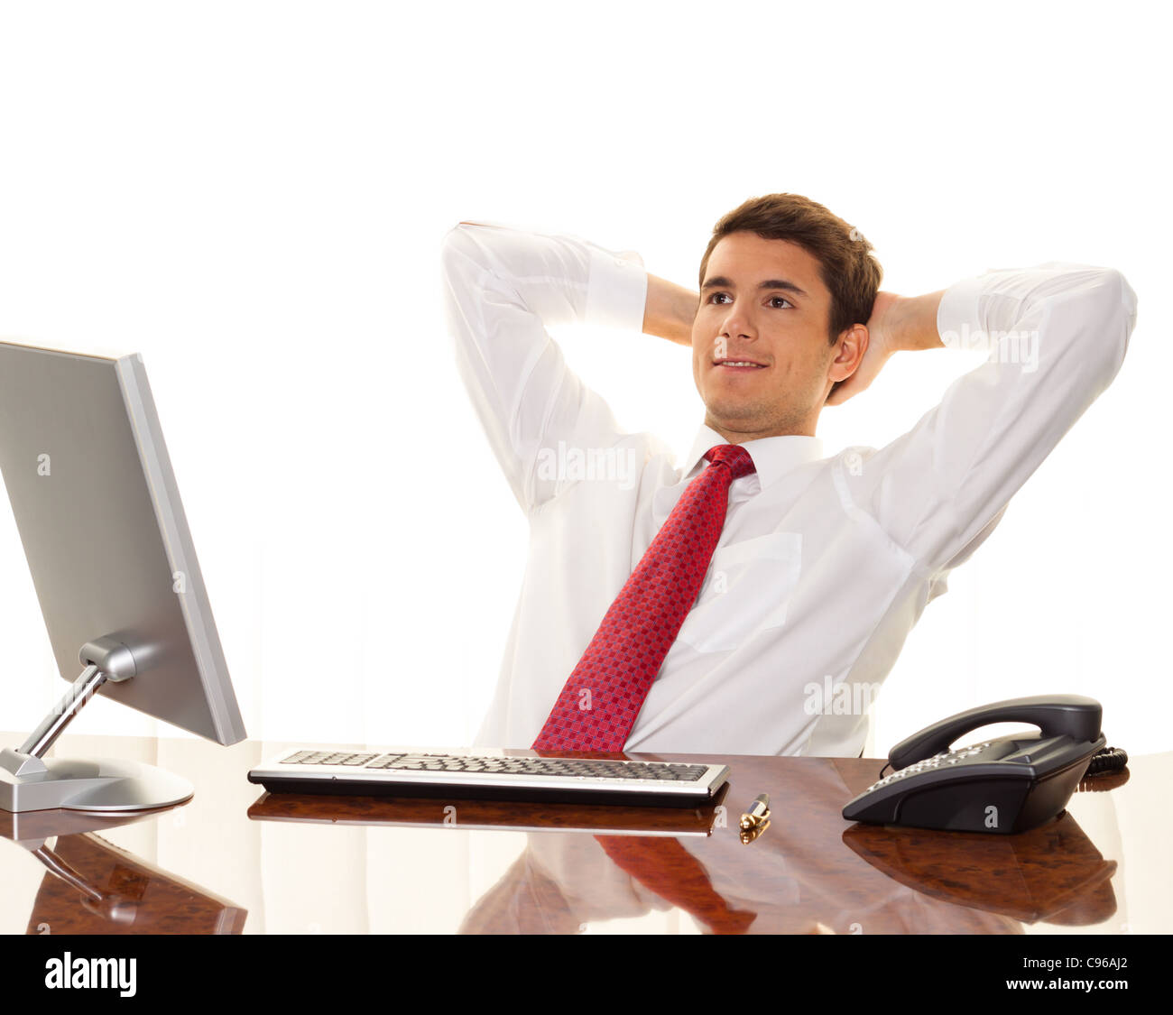 A successful young manager sitting at a desk and smiles Stock Photo - Alamy