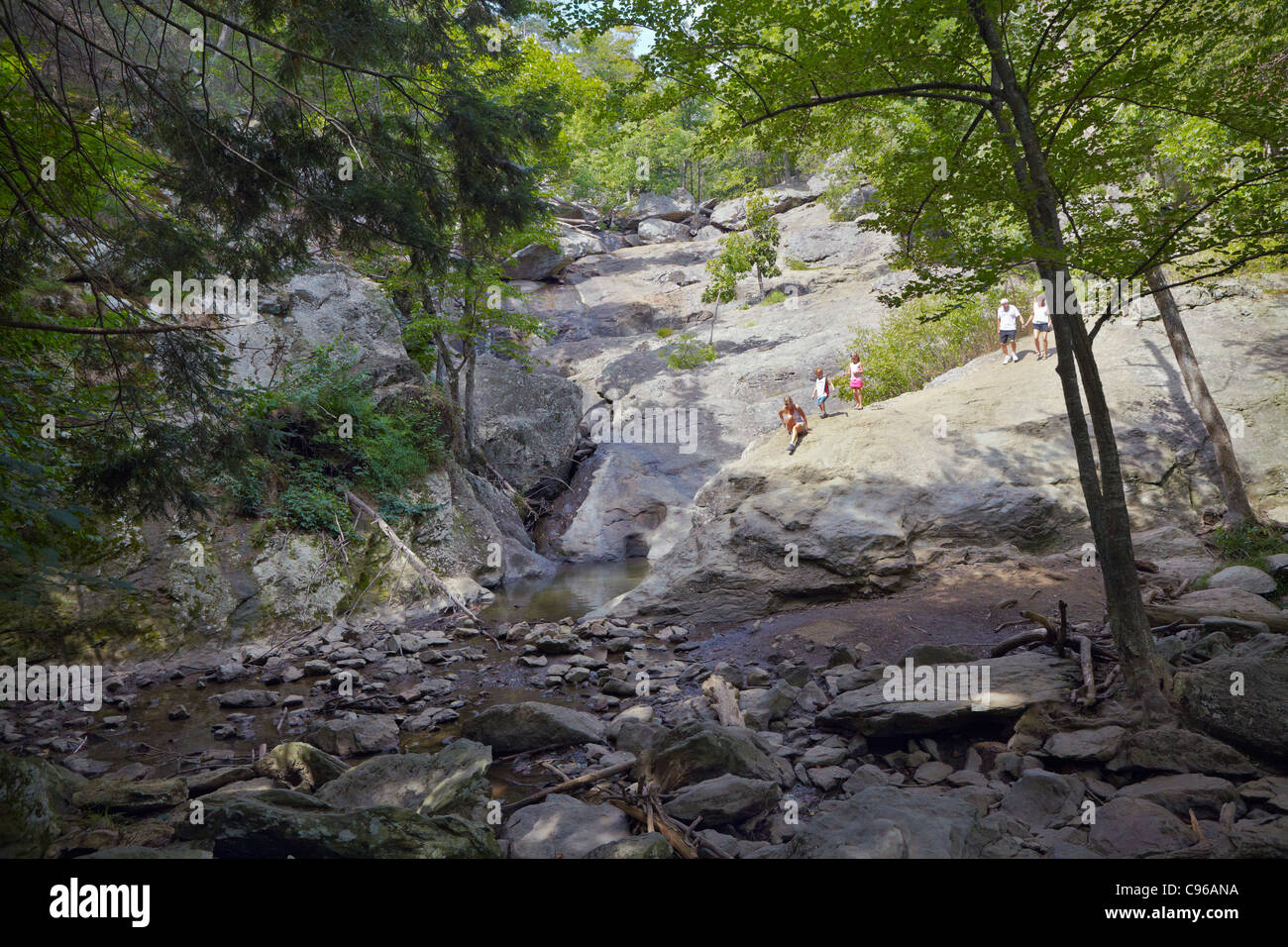 Park visitors climbing down the rock face of Cunningham Falls (during ...