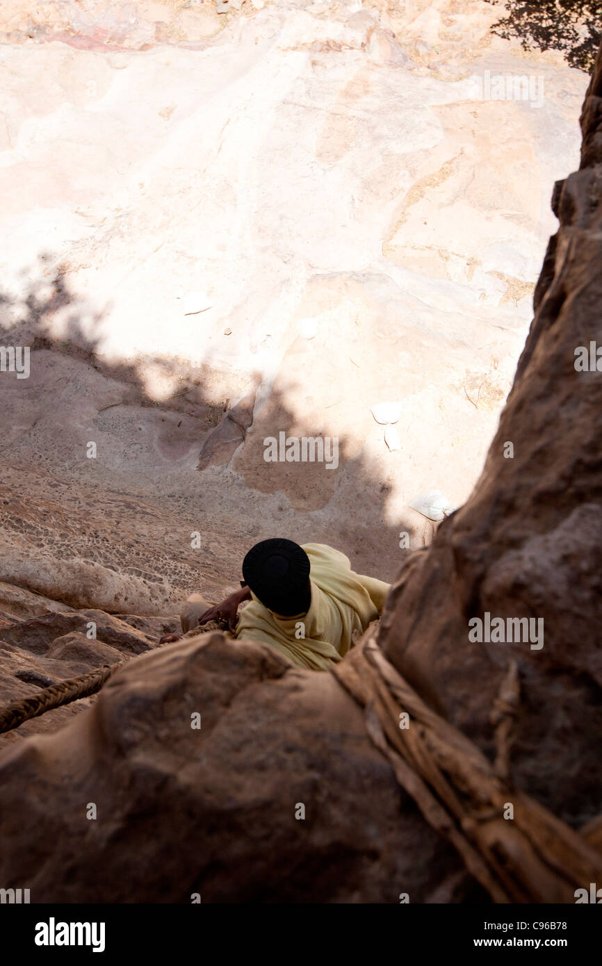 An Orthodox Christian priest descends the cliff-top monastery Debre ...
