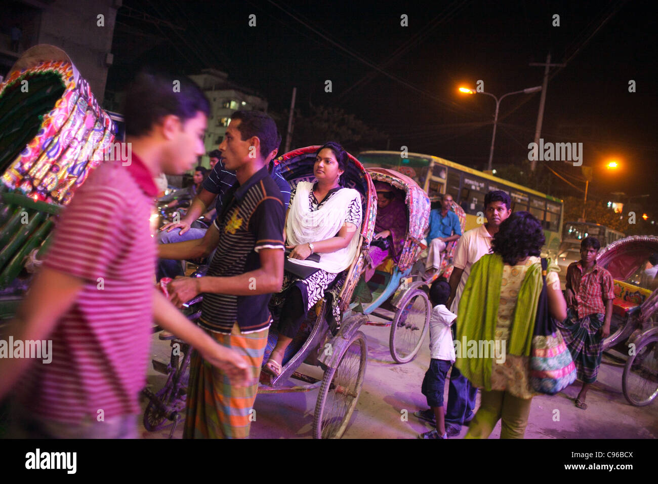 A woman sits in a rickshaw shortly before getting of Stock Photo - Alamy