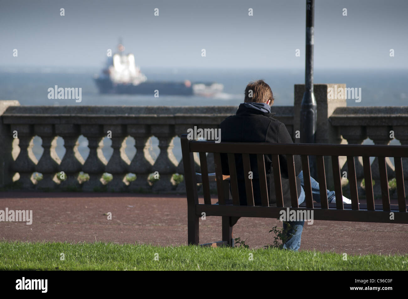 Lonely man sitting on bench Stock Photo - Alamy