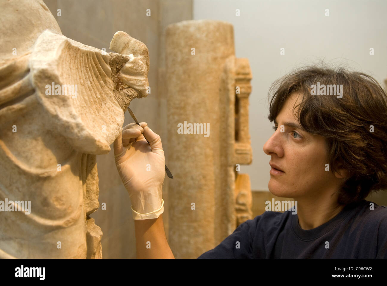 Archaeologist carrying out restoration work on an artefact at Beirut's ...