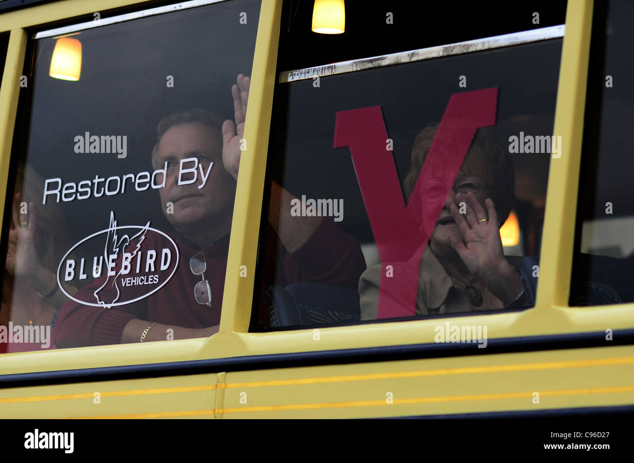 Passengers waving goodbye through a bus window Stock Photo - Alamy