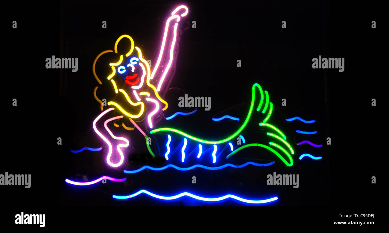 Mermaid floating on her back neon sign Stock Photo - Alamy