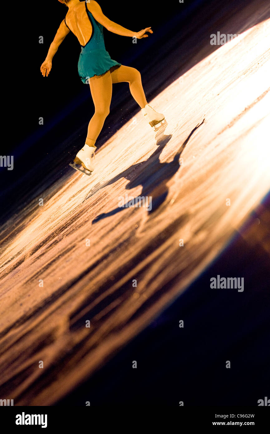Shadow of female figure skater in action Stock Photo - Alamy