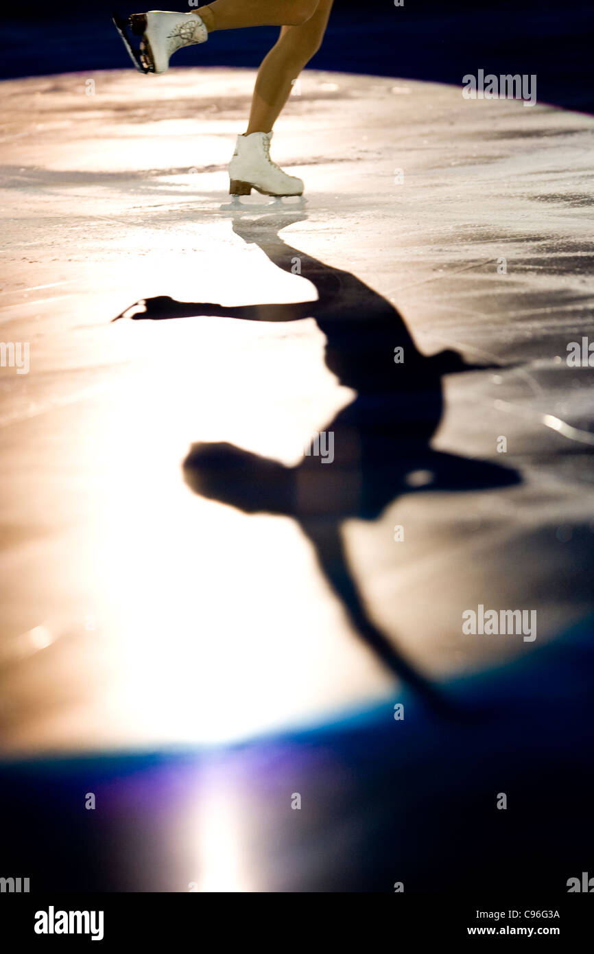 Shadow of female figure skater in action Stock Photo - Alamy