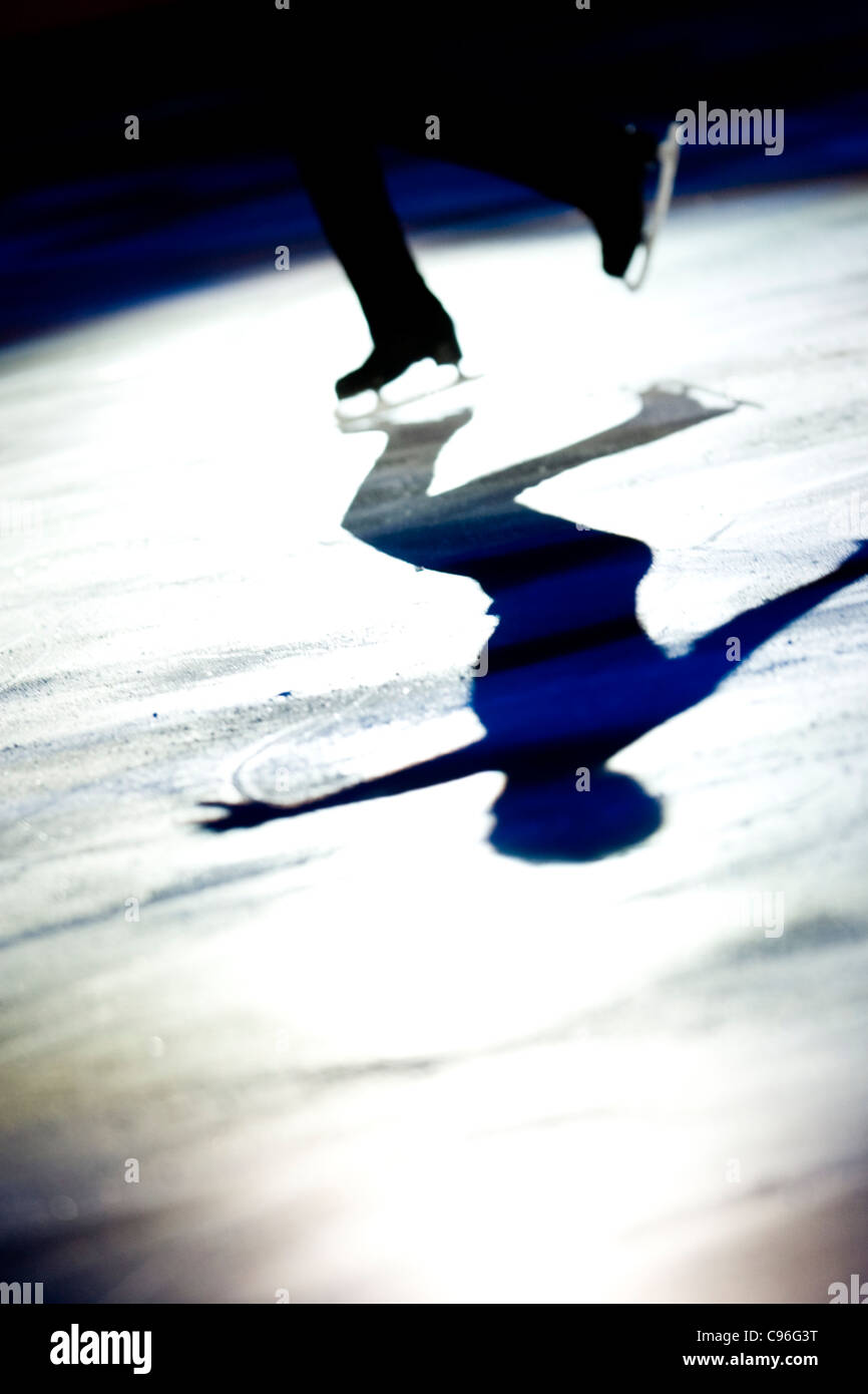 Shadow of female figure skater in action Stock Photo - Alamy