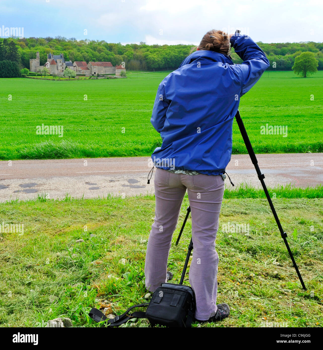 Landscape photographer photographing the Chateau de Faulin in Burgundy ...