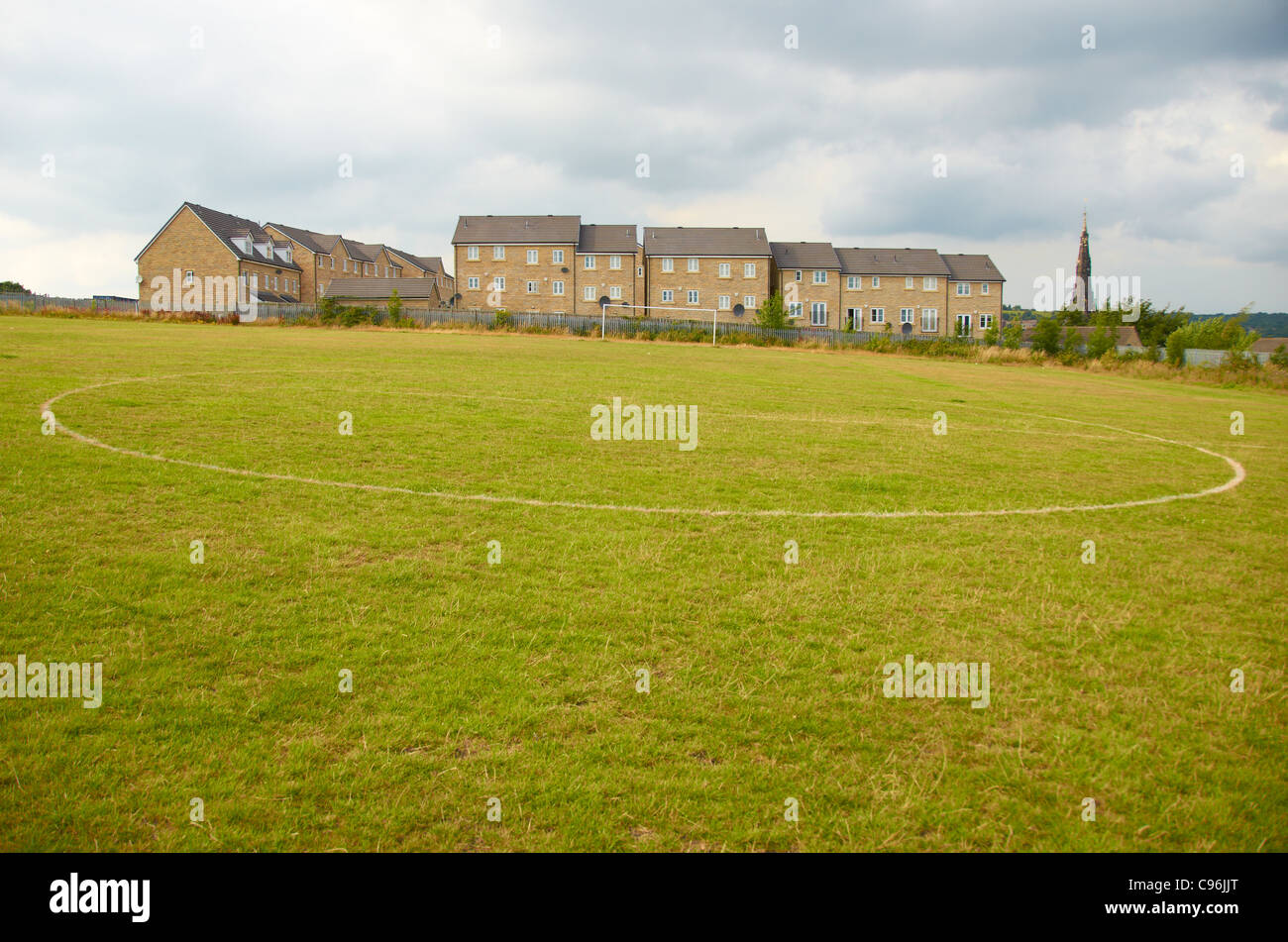New build houses backing onto a football pitch / sports ground Stock ...