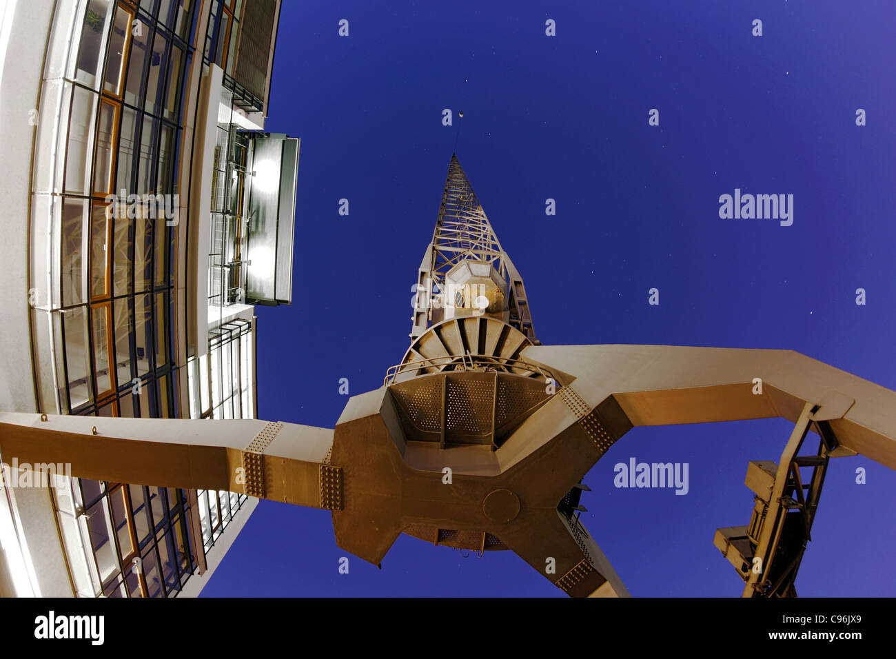 worm view of historic Harbour Crane at night, Neumuehlen district ...